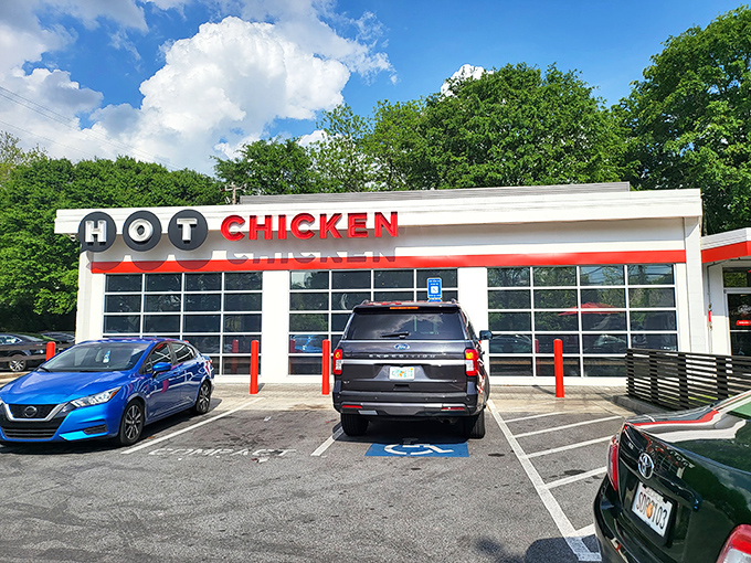 Welcome to flavor town! Hattie B's exterior promises a spicy adventure, with its bold signage and inviting storefront beckoning chicken enthusiasts.