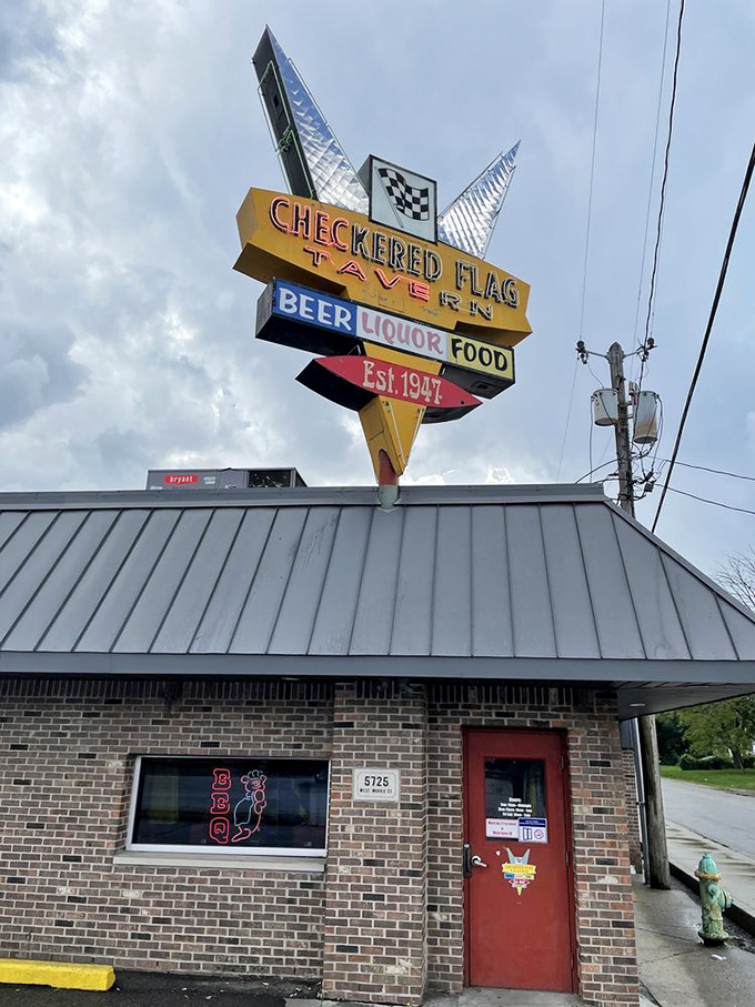Welcome to flavor town! The Checkered Flag Tavern's iconic sign promises a pit stop for your taste buds, serving up Hoosier hospitality since 1947.