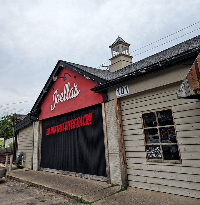 Welcome to flavor town! Joella's exterior promises a spicy adventure with its bold red facade and cheeky slogan.
