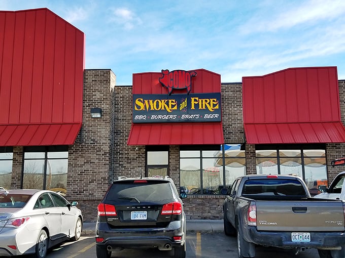 The bright red roof of Como Smoke and Fire stands out like a beacon for hungry travelers. This barbecue sanctuary in Columbia promises smoky delights within its brick walls.