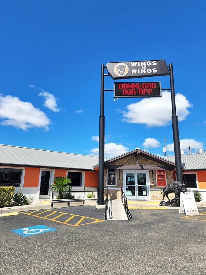 The orange and stone exterior of Wings and Rings stands proudly against the Texas sky, like a beacon calling all wing enthusiasts home.