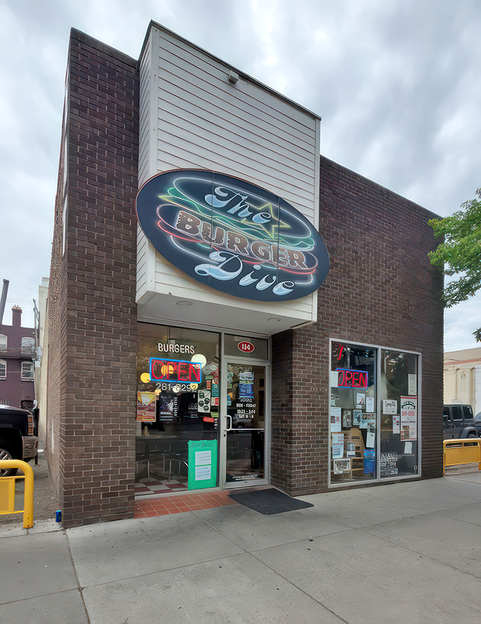 Step into burger paradise! The Burger Dive's retro neon sign beckons, while a majestic bison mural keeps watch. It's like a time-traveling foodie's dream come true. 