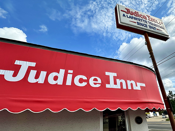 A beacon of burger bliss! Judice Inn's iconic red awning and retro sign promise a journey back to simpler, tastier times.