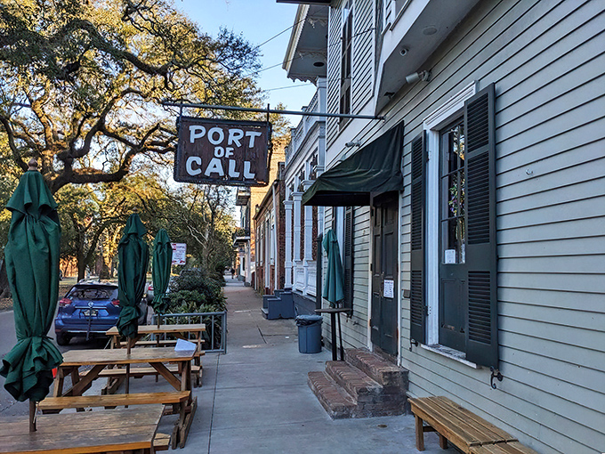 A siren call for burger lovers! Port of Call's weathered sign promises a no-frills feast that'll have you anchored to your seat.