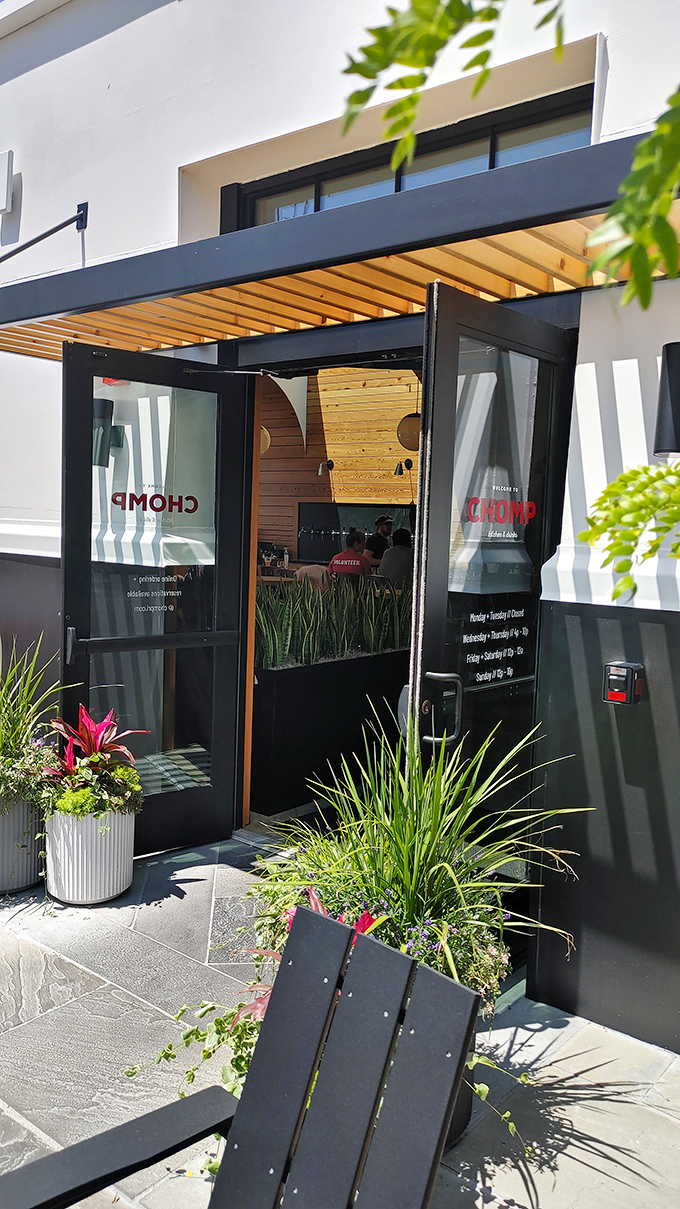 Welcome to burger paradise! Chomp's exterior beckons with its clean lines and inviting patio that promises a cozy evening of culinary delights.