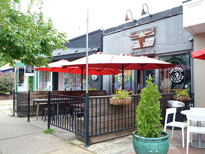 Welcome to burger paradise! Jack Brown's exterior promises a laid-back vibe with its red umbrellas and cozy patio seating. It's like a backyard BBQ, but with better burgers.