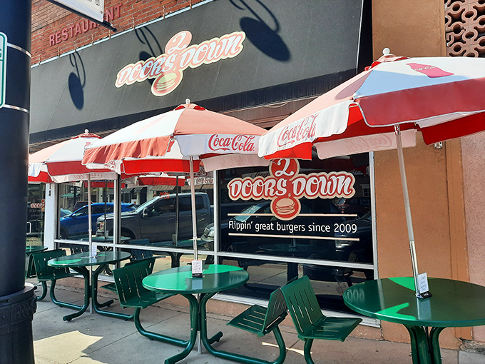 Welcome to burger paradise! 2 Doors Down's inviting storefront promises a feast for the senses, with those red umbrellas practically winking at you to come inside.