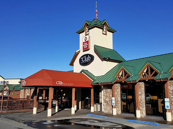 A beacon of deliciousness! The Club Tavern and Grill stands tall, its yellow exterior and red awning beckoning hungry travelers like a culinary lighthouse in the heart of Bozeman. 