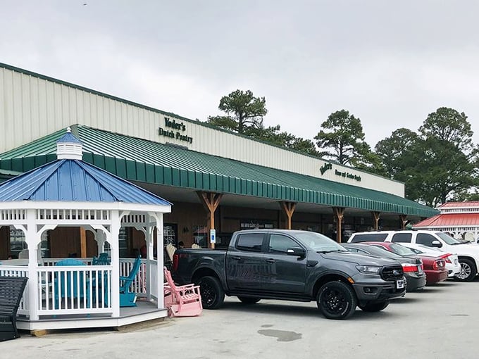 The unassuming exterior of Yoder's Dutch Pantry, where that blue gazebo practically whispers, "Sit a spell after you've consumed your weight in cinnamon rolls."