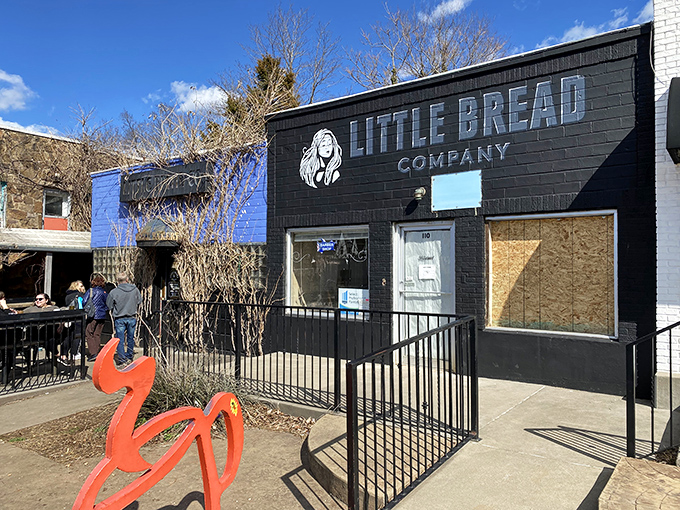 Welcome to carb heaven! Little Bread Company's exterior is like a siren call to bread lovers, with its sleek black facade and eye-catching logo.