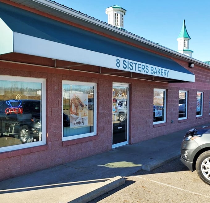 A pink paradise for pastry lovers! 8 Sisters Bakery's charming exterior is like a life-sized dollhouse, complete with a welcoming green awning and a vibrant neon sign that screams good food.