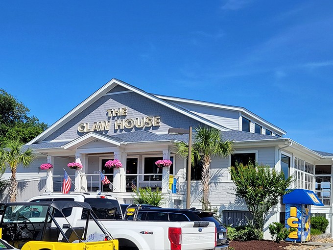 Welcome to seafood paradise! The Claw House stands proud, a beacon of deliciousness with its crisp white exterior and inviting palm trees. 