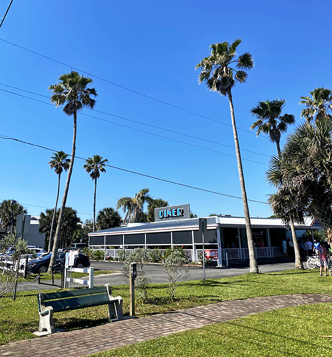 Palm trees and promise: This classic diner beckons like a mirage in the Florida sun, promising comfort food and coastal charm.