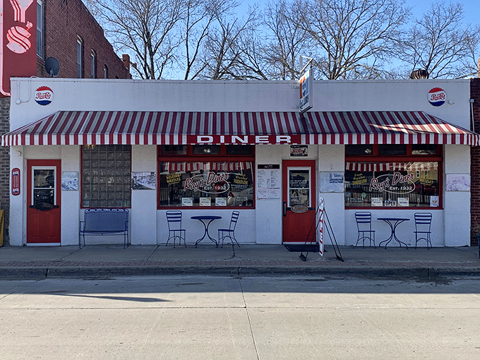The classic white facade with red-striped awning isn't just inviting&mdash;it's practically a time machine to when breakfast cost less than your morning latte.