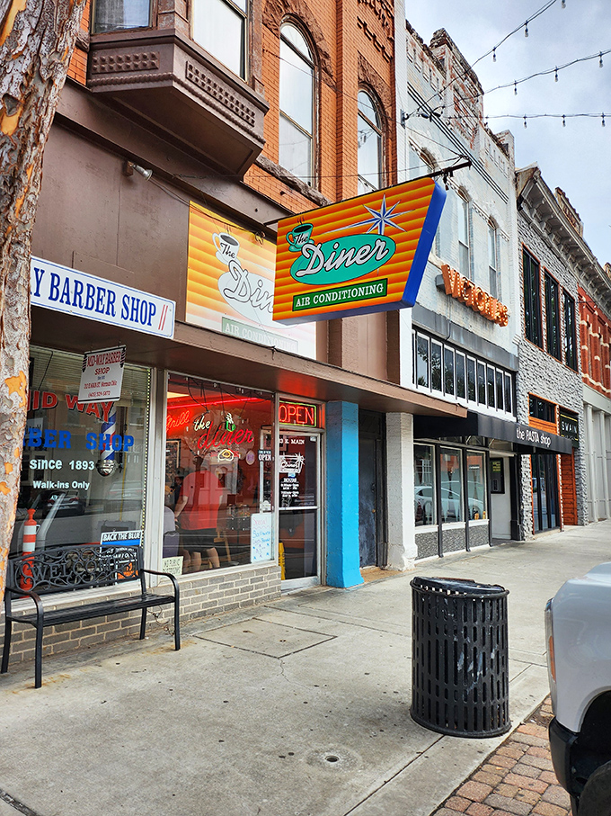 That iconic orange and teal sign doesn't just promise air conditioning&mdash;it's announcing your arrival at breakfast paradise on Main Street.