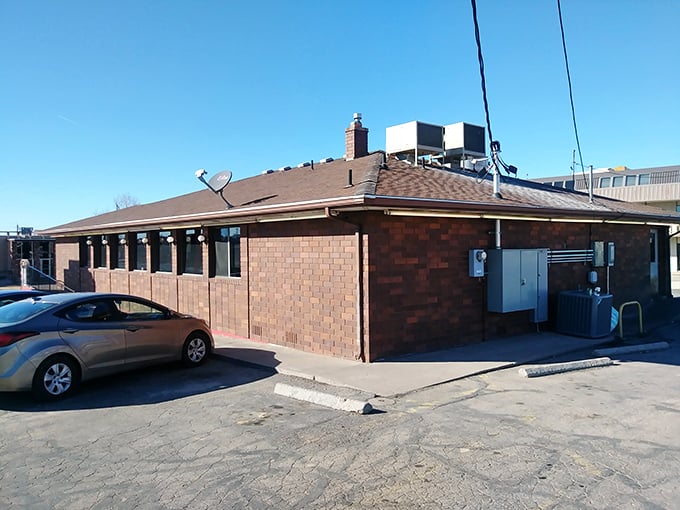 The classic roadside sign beckons like a lighthouse for hungry travelers. Against that perfect Utah blue sky, it promises comfort food salvation just off the highway.
