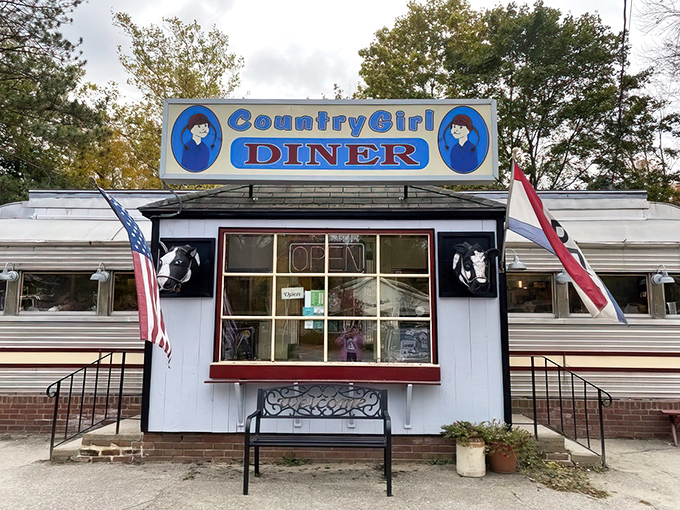 The classic silver diner car with its bright blue sign stands like a time capsule on Route 103, promising comfort food and conversations that matter.