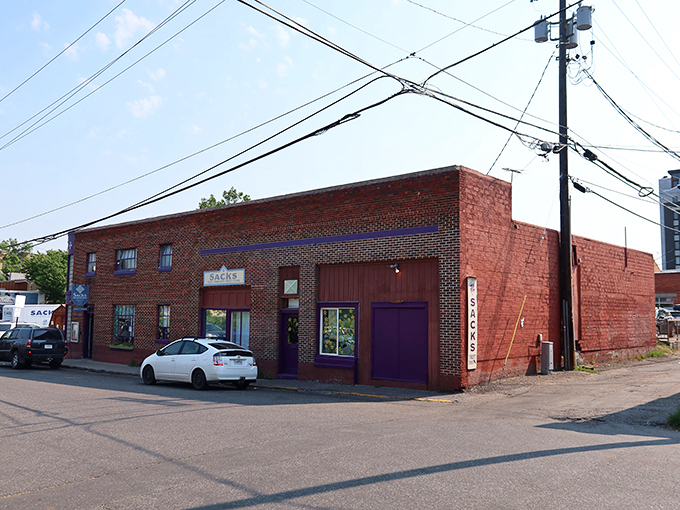 A brick facade with a pop of purple - Sacks Thrift Store beckons bargain hunters like a siren call to sailors of savings.