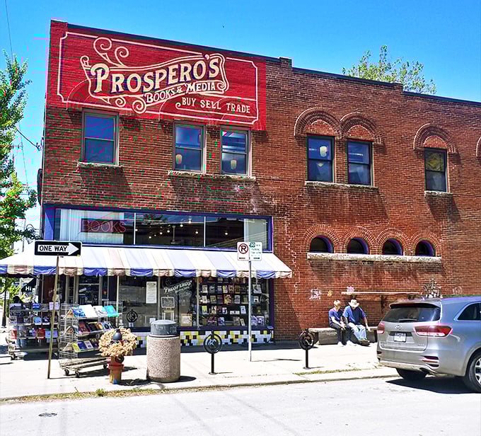 A literary beacon in brick and mortar! Prospero's Books stands tall, its vibrant red sign a siren call to bibliophiles and curious souls alike.