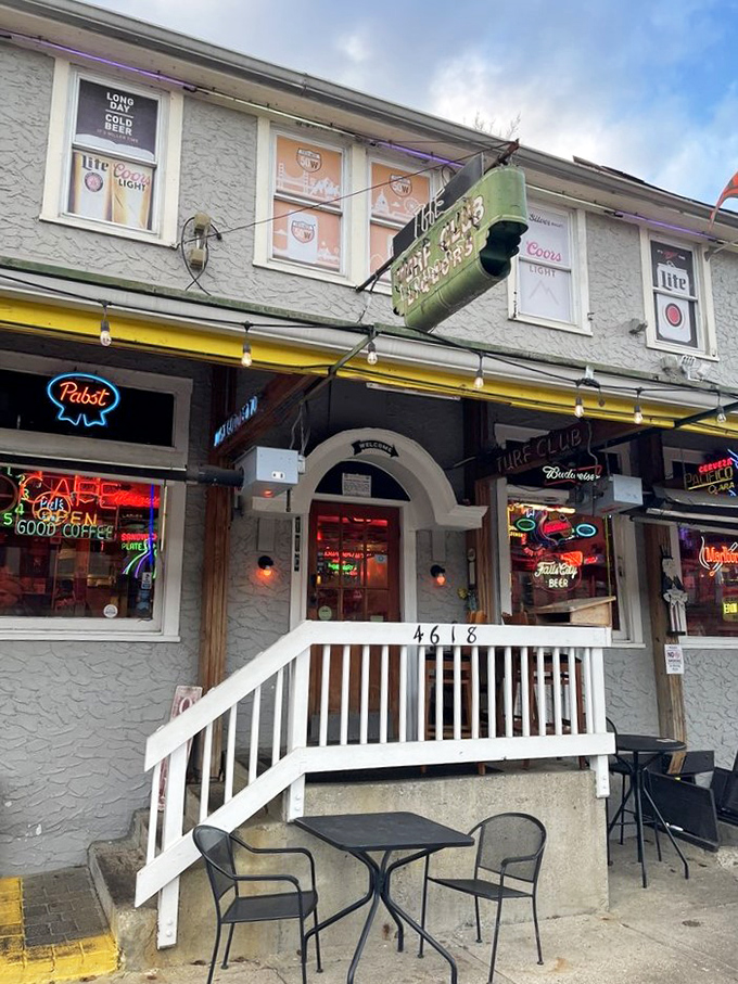 Welcome to neon nirvana! The Turf Club's exterior is a kaleidoscope of kitsch, where every sign tells a story and flowers bloom in defiance of urban sprawl.