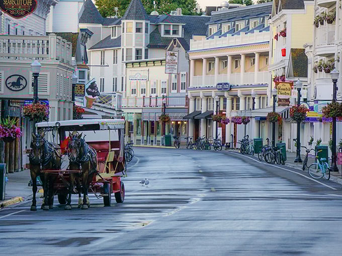 Step back in time on Mackinac Island's Main Street, where horse-drawn carriages and bicycles reign supreme. It's like someone hit pause on the 19th century, but with better ice cream options.