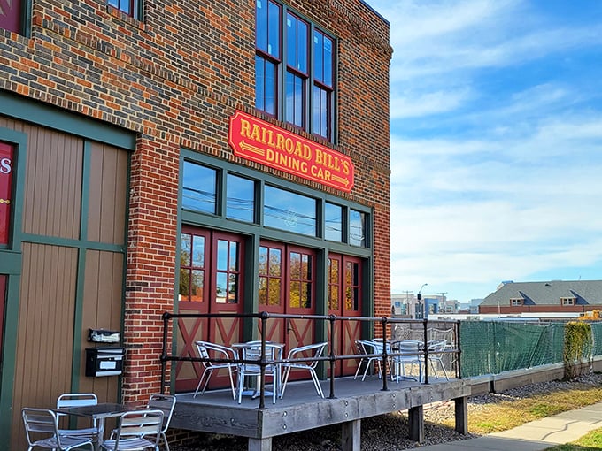 All aboard the flavor express! Railroad Bill's Dining Car beckons with its charming brick facade and inviting wooden deck, promising a journey through culinary delights.