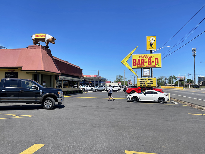 Welcome to BBQ paradise! Bob Sykes' iconic sign beckons like a smoky siren, promising meaty delights that'll make your taste buds do a happy dance.