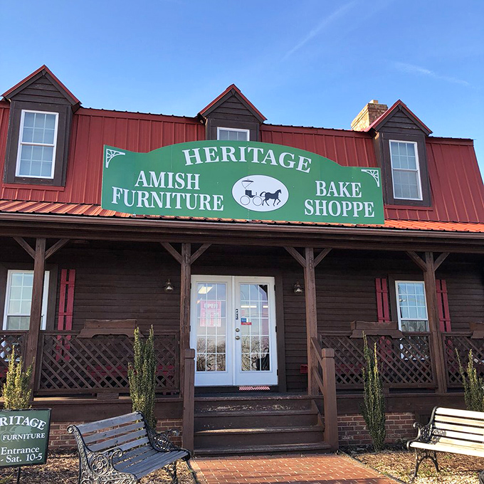 The red metal roof and welcoming wooden porch of Heritage Bake Shoppe stand as a rustic oasis amid Virginia Beach's coastal landscape.
