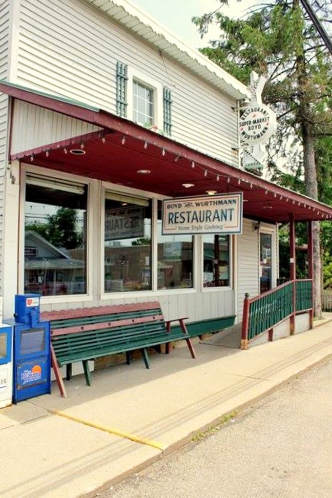 The white clapboard exterior of Boyd & Wurthmann stands as a time capsule in Berlin, where Amish buggies park alongside modern vehicles in perfect small-town harmony.