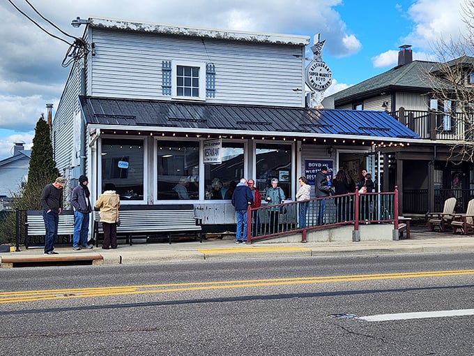 The white clapboard exterior of Boyd & Wurthmann stands as a time capsule in Berlin, where Amish buggies park alongside modern vehicles in perfect small-town harmony.