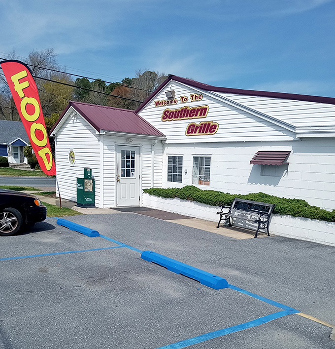 The unassuming white exterior with its bold "FOOD" flag is like a secret handshake among locals who know where real flavor lives.