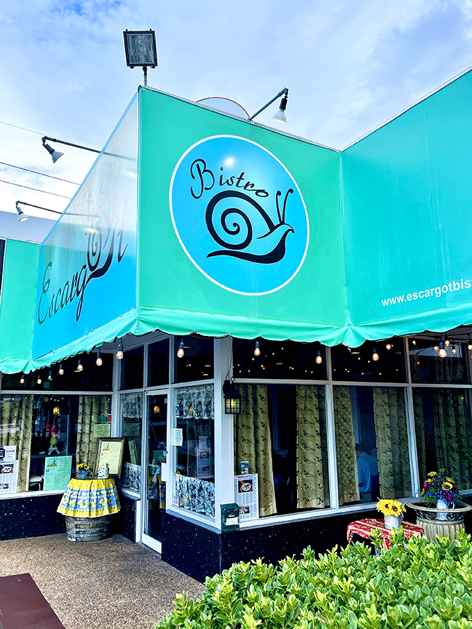 A slice of Paris in the Sunshine State! Escargot Bistro's vibrant awning beckons like a Gallic lighthouse in a sea of palm trees.