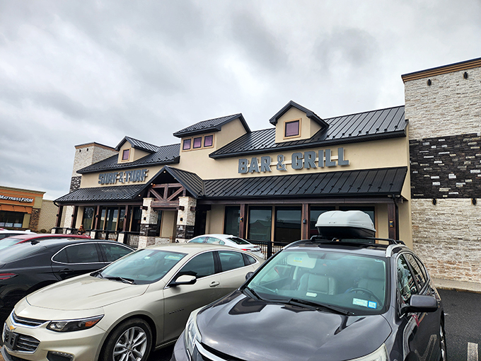 A culinary beacon in Milford! Surf & Turf Bar & Grill's exterior promises a feast for the senses, with its inviting wooden accents and twinkling lights.