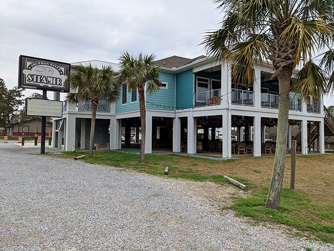 Seafood paradise found! This teal-hued haven on stilts is where lobster dreams and crab cravings come to life.