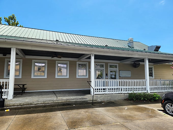 Home sweet smokehouse! This charming cottage-style exterior with its inviting porch says "grandma's cooking" before you even walk through the door. 
