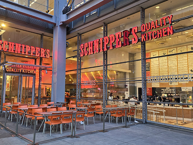 That iconic red Schnipper's sign beckons like a neon promise of comfort food nirvana. The orange chairs outside practically scream "sit here and be happy!" 
