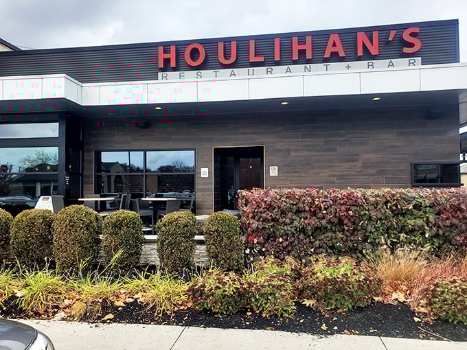 The beacon of comfort food gleams, with Houlihan's warm glow inviting hungry travelers like moths to a buttery, potato-scented flame.