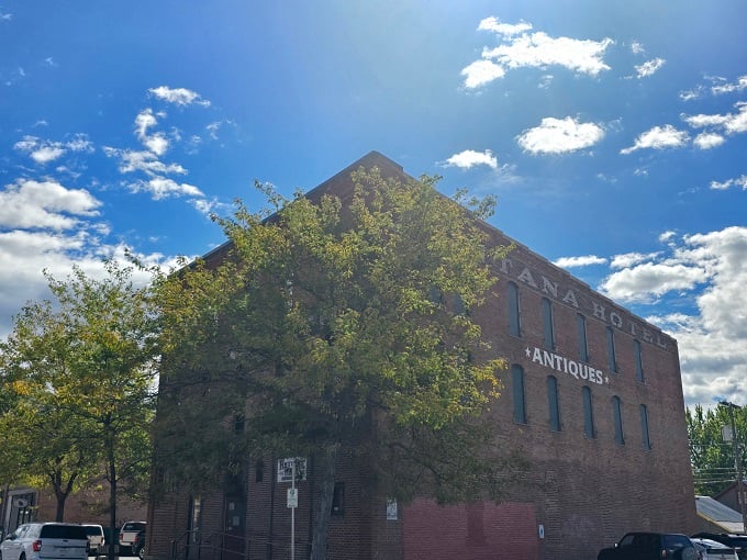 "Montana Hotel" or "Time Machine"? This brick behemoth beckons with the promise of treasures from yesteryear. Step inside, and let the hunt begin!
