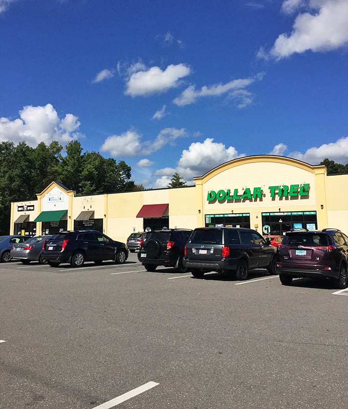 The Salem Dollar Tree stands like a budget-friendly beacon under New Hampshire's blue skies, promising affordable treasures within its unassuming yellow exterior.