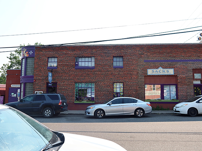 A brick facade with a pop of purple - Sacks Thrift Store beckons bargain hunters like a siren call to sailors of savings.
