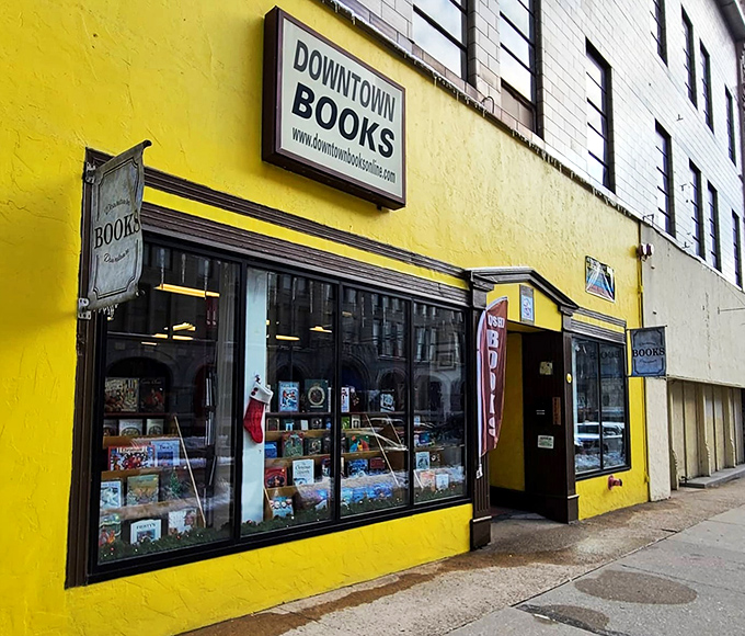 A literary oasis in a sea of concrete! Downtown Books' vibrant yellow exterior is like a beacon for bibliophiles, promising adventures within its walls.