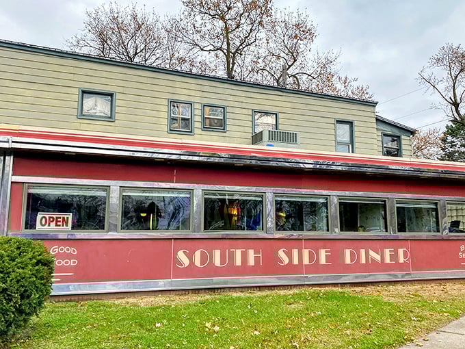 Step back in time! This retro-chic diner exterior is like a portal to the 1950s, complete with cherry-red accents and inviting blue umbrellas.