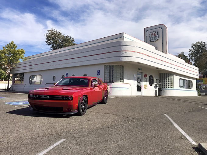 Step into a time machine disguised as a diner! This gleaming white exterior with blue trim screams "1950s Americana" louder than a jukebox playing Elvis.