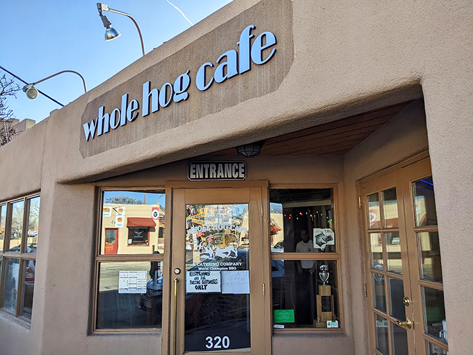 Welcome to flavor town! Whole Hog Caf&eacute;'s adobe exterior is like a siren song for barbecue lovers, with that American flag waving you in for a taste of smoky paradise.