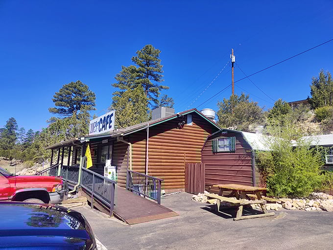 The log cabin charm of June's Cafe stands proudly against Arizona's blue sky, complete with American flag &ndash; a beacon of breakfast hope for hungry travelers.
