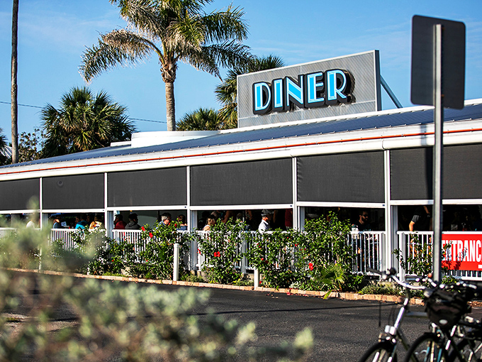 Palm trees and promise: This classic diner beckons like a mirage in the Florida sun, promising comfort food and coastal charm.