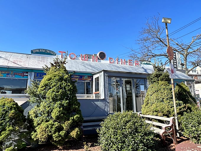 The iconic curved roof and turquoise trim of Deluxe Town Diner stands as a beacon of breakfast hope on Mt. Auburn Street.