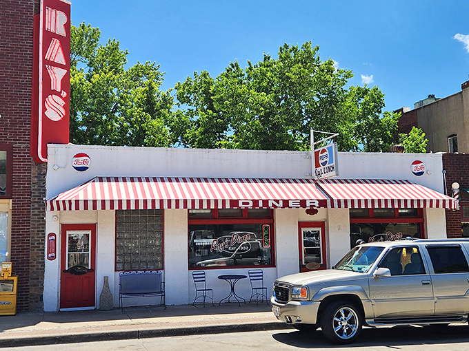 The classic white facade with red-striped awning isn't just inviting&mdash;it's practically a time machine to when breakfast cost less than your morning latte.