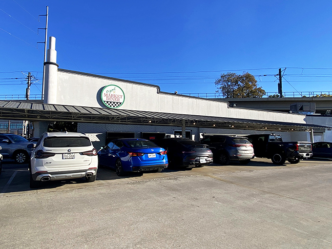 The iconic circular sign of Original Market Diner stands tall against the Dallas sky, a beacon for breakfast enthusiasts since the 1950s.