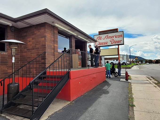 The classic roadside sign beckons like a lighthouse for hungry travelers. Against that perfect Utah blue sky, it promises comfort food salvation just off the highway.